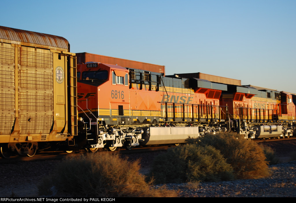 BNSF 6816 and BNSF 6813 pass BNSF 6795's Z Train going west as they slow down to enter the BNSF ...